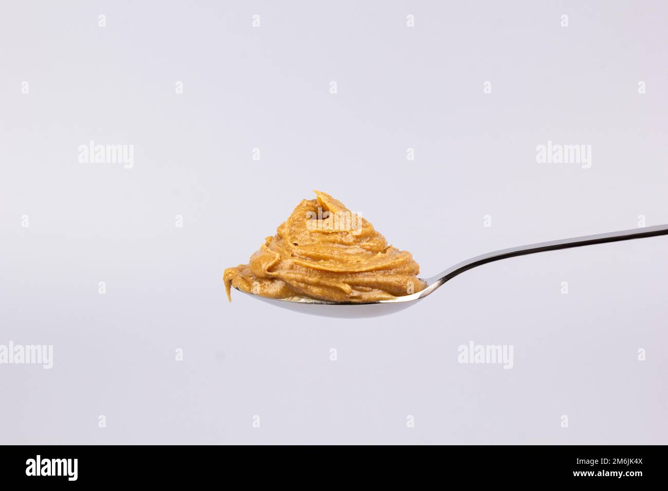 Delicious creamy peanut butter is laid out in a beautiful slide in a ...