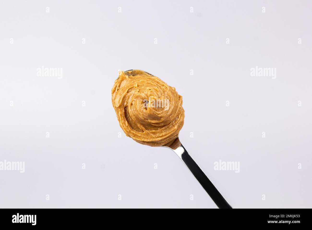 Delicious creamy peanut butter is laid out in a beautiful slide in a ...