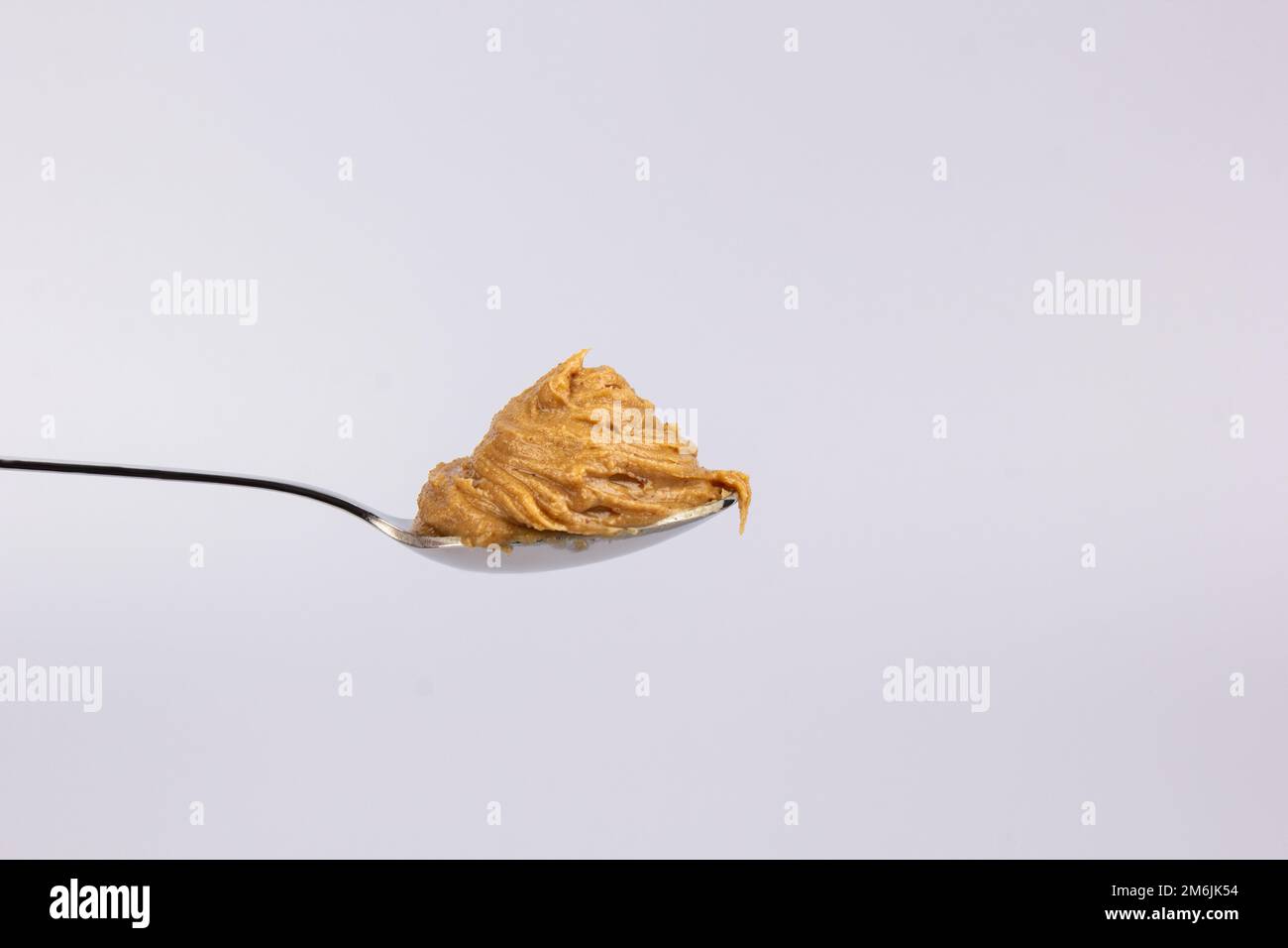 Delicious creamy peanut butter is laid out in a beautiful slide in a ...