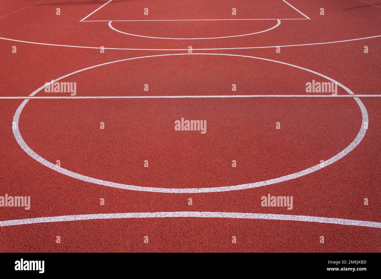 Red plastic covering on the playground, circles and white stripe ...
