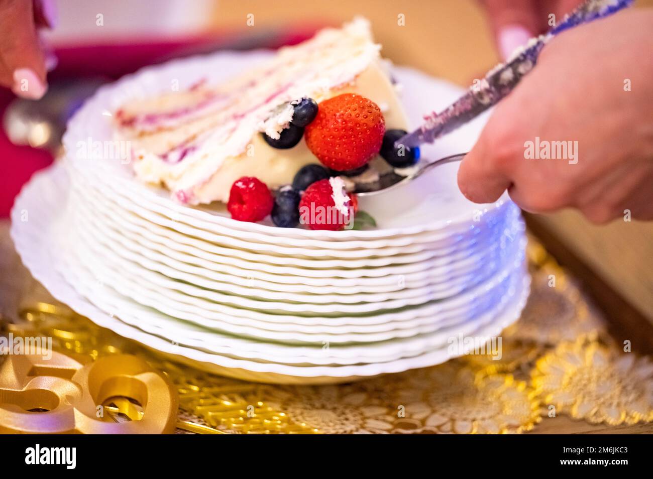 Woman cutting cake Stock Photo - Alamy