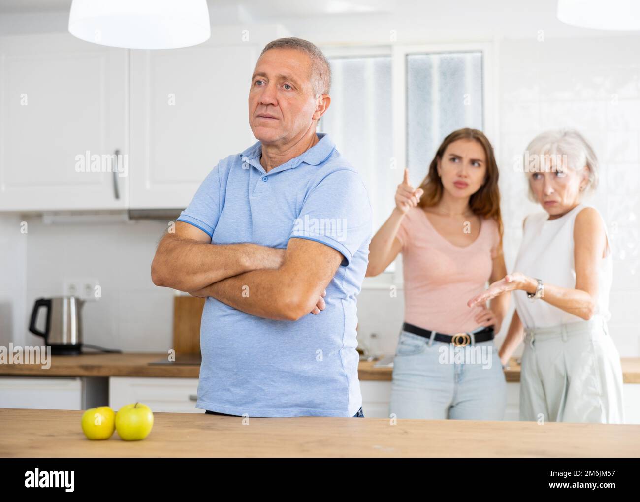 Upset father standing in the kitchen Stock Photo - Alamy