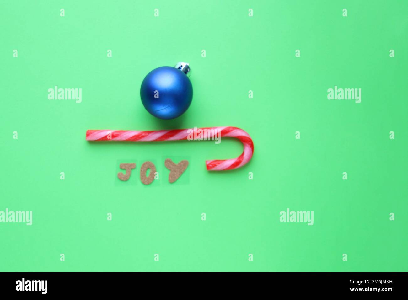 Merry Christmas card. Joy text and Candy cane Stock Photo - Alamy