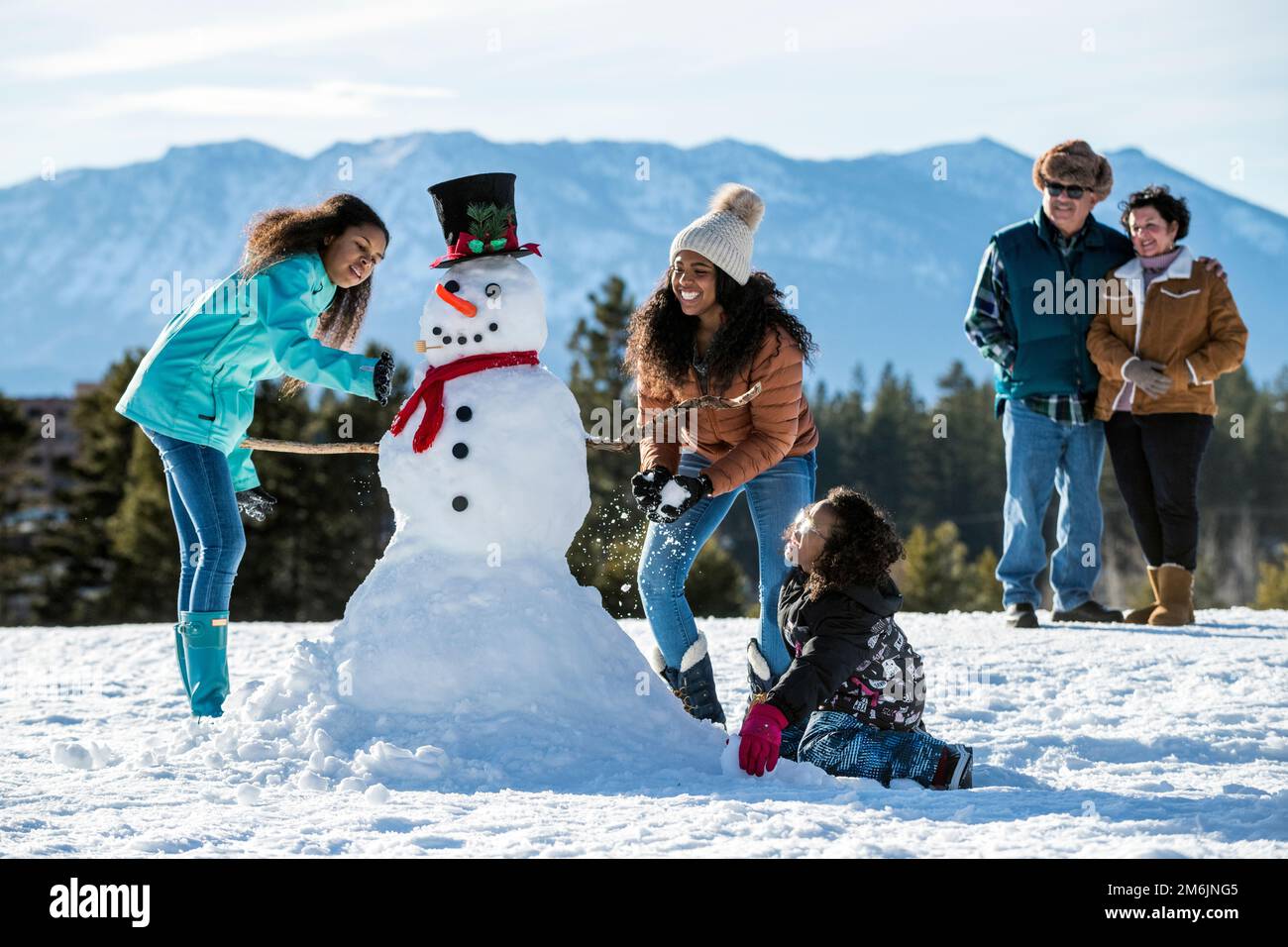 A family building a snowman in Stateline, Nevada Stock Photo - Alamy