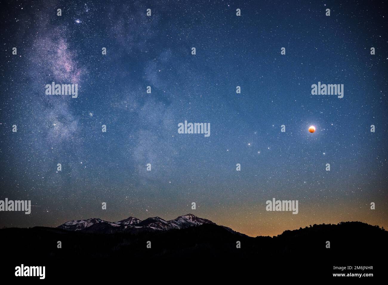 Lunar eclipse and Milky Way at night in Sierra Nevada Stock Photo - Alamy