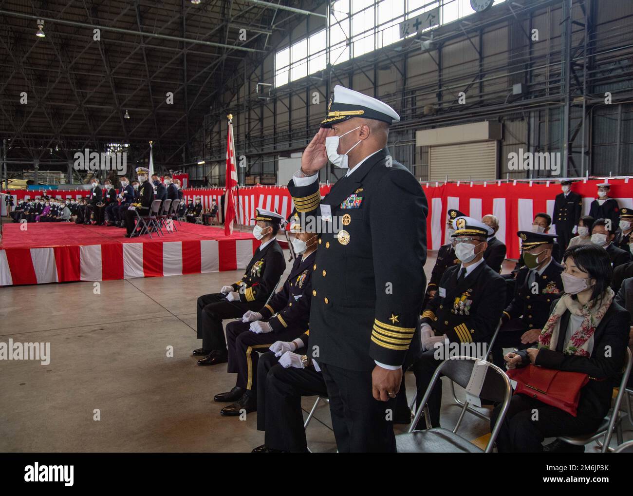 Capt. David Adams, Commander, Fleet Activities Sasebo (CFAS) salutes ...