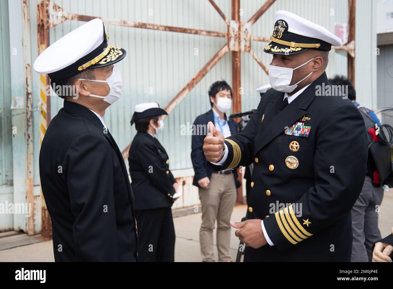Capt. David Adams, Commander, Fleet Activities Sasebo, speaks with ...