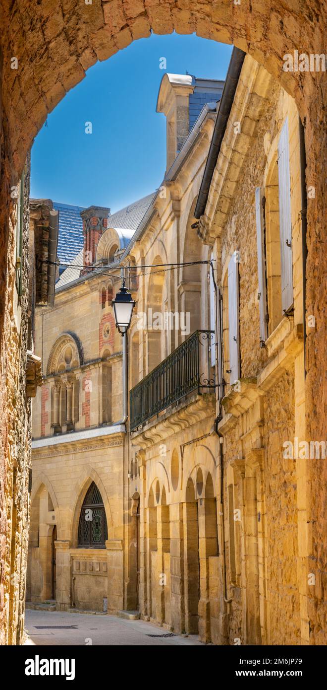 Narrow street and stone archway in the historic village center of ...