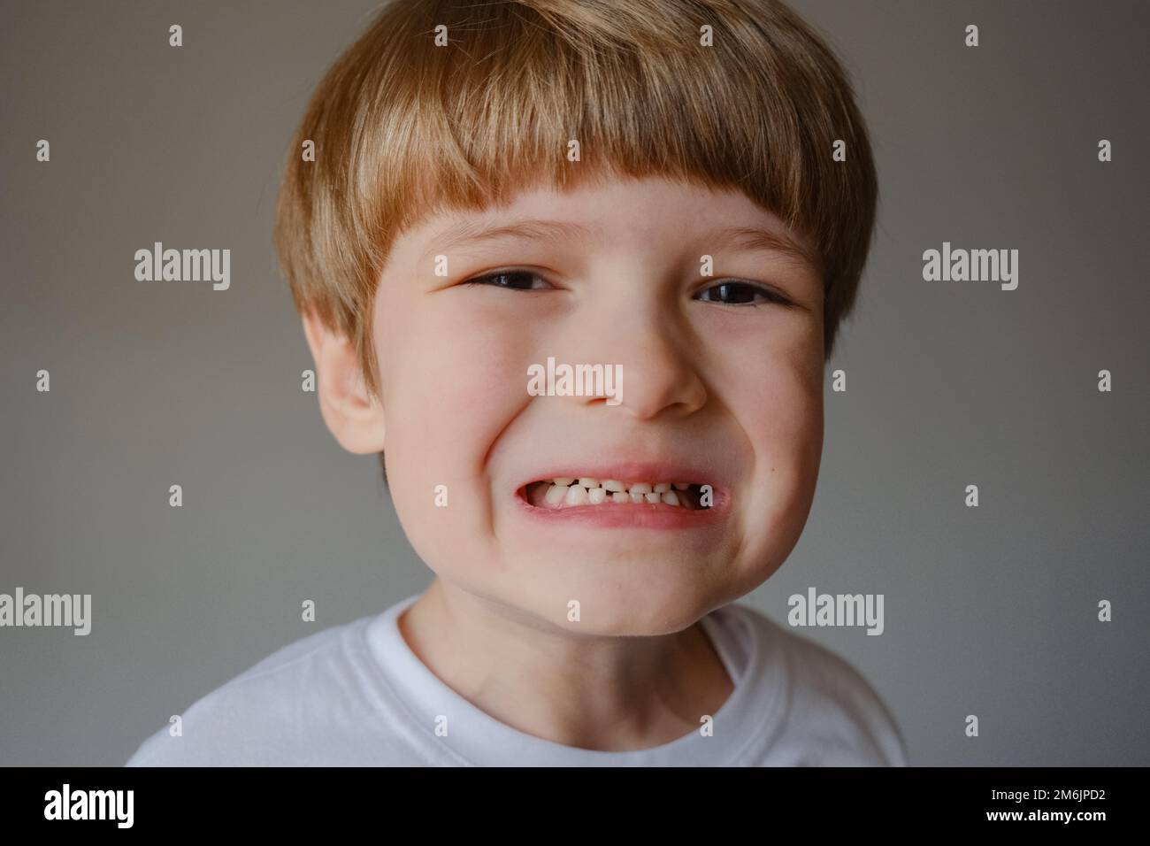 Closeup portrait of a kid showing his milk teeth, smiling Stock Photo ...