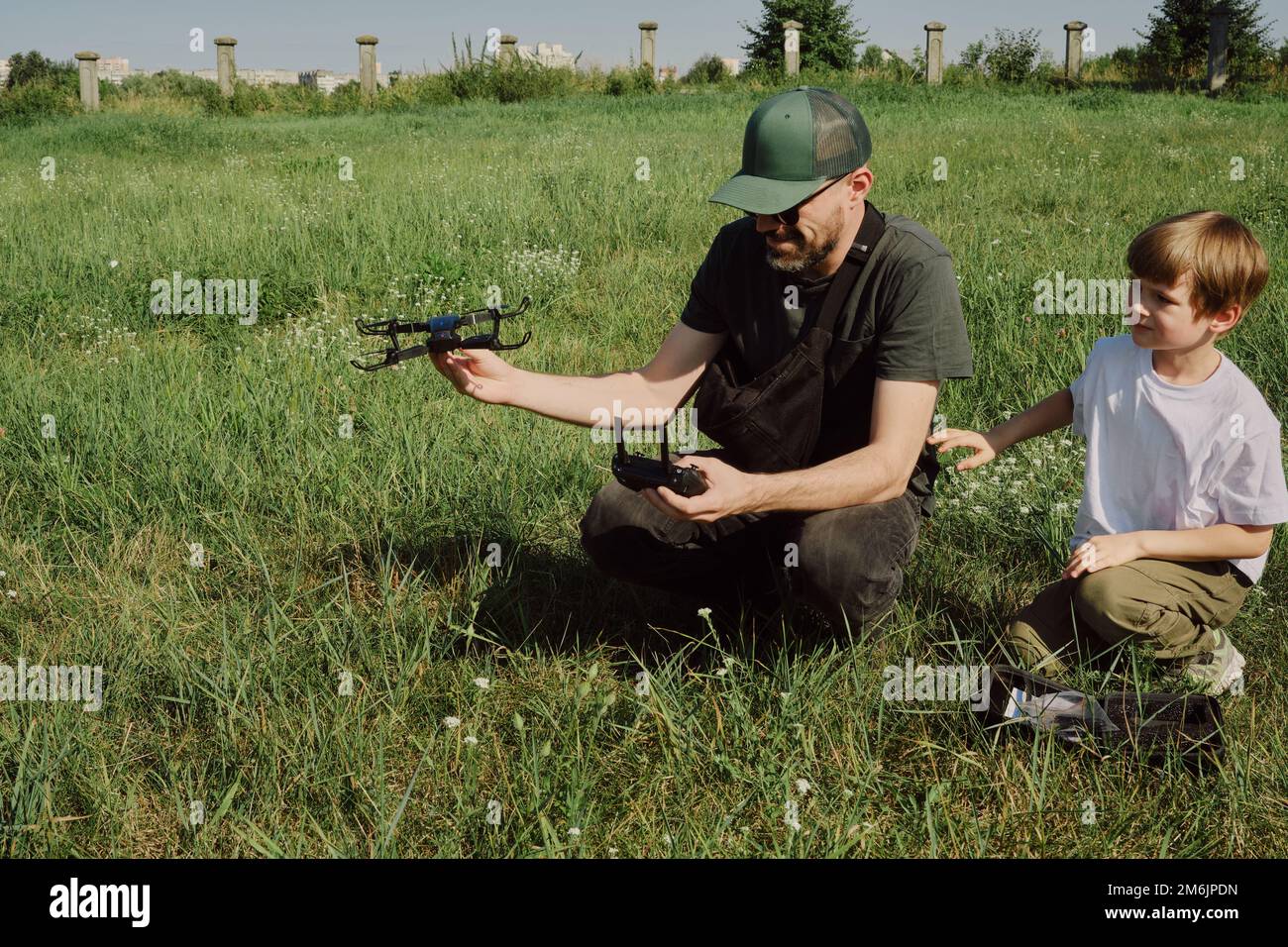 Father and son playing with flying drone, family Stock Photo - Alamy