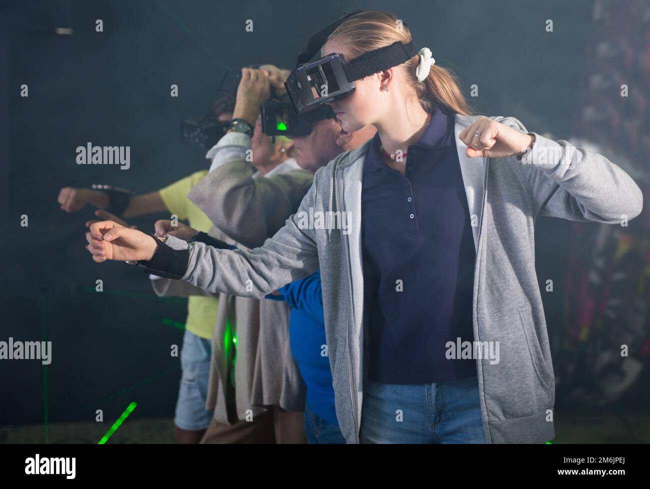Teenage girl playing VR games with her family Stock Photo - Alamy