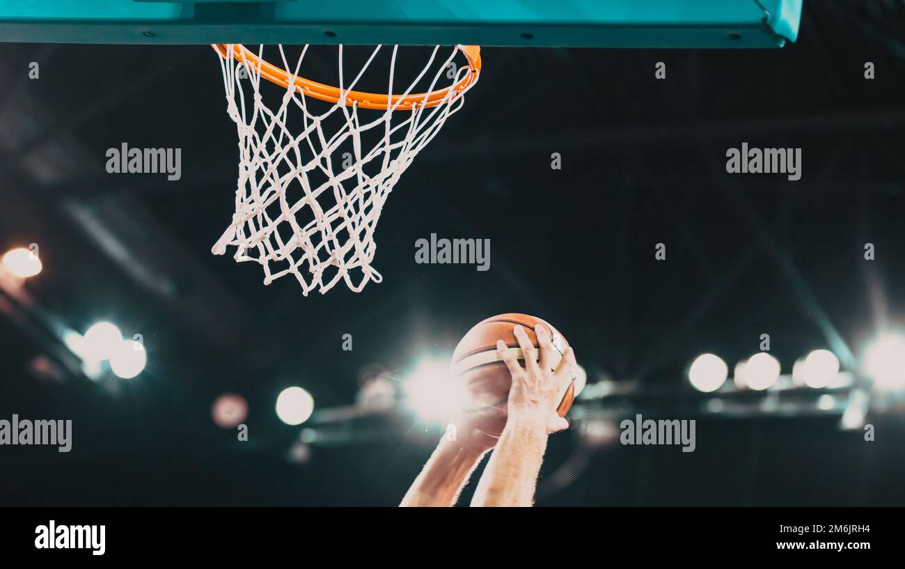 Basketball game ball in hoop Stock Photo - Alamy