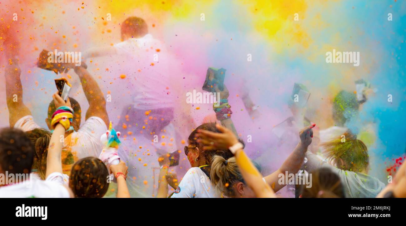 Color festival in city crowd celebrating Stock Photo - Alamy