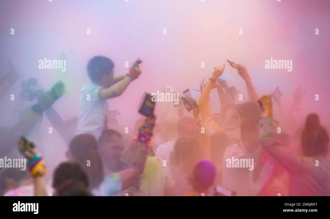 Color festival in city crowd celebrating Stock Photo - Alamy