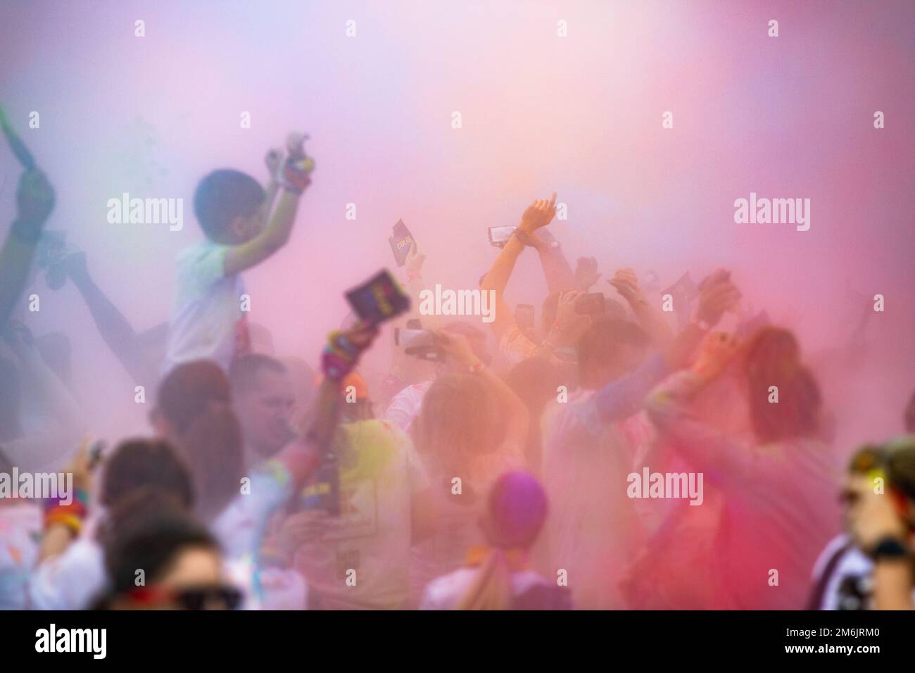 Color festival in city crowd celebrating Stock Photo - Alamy