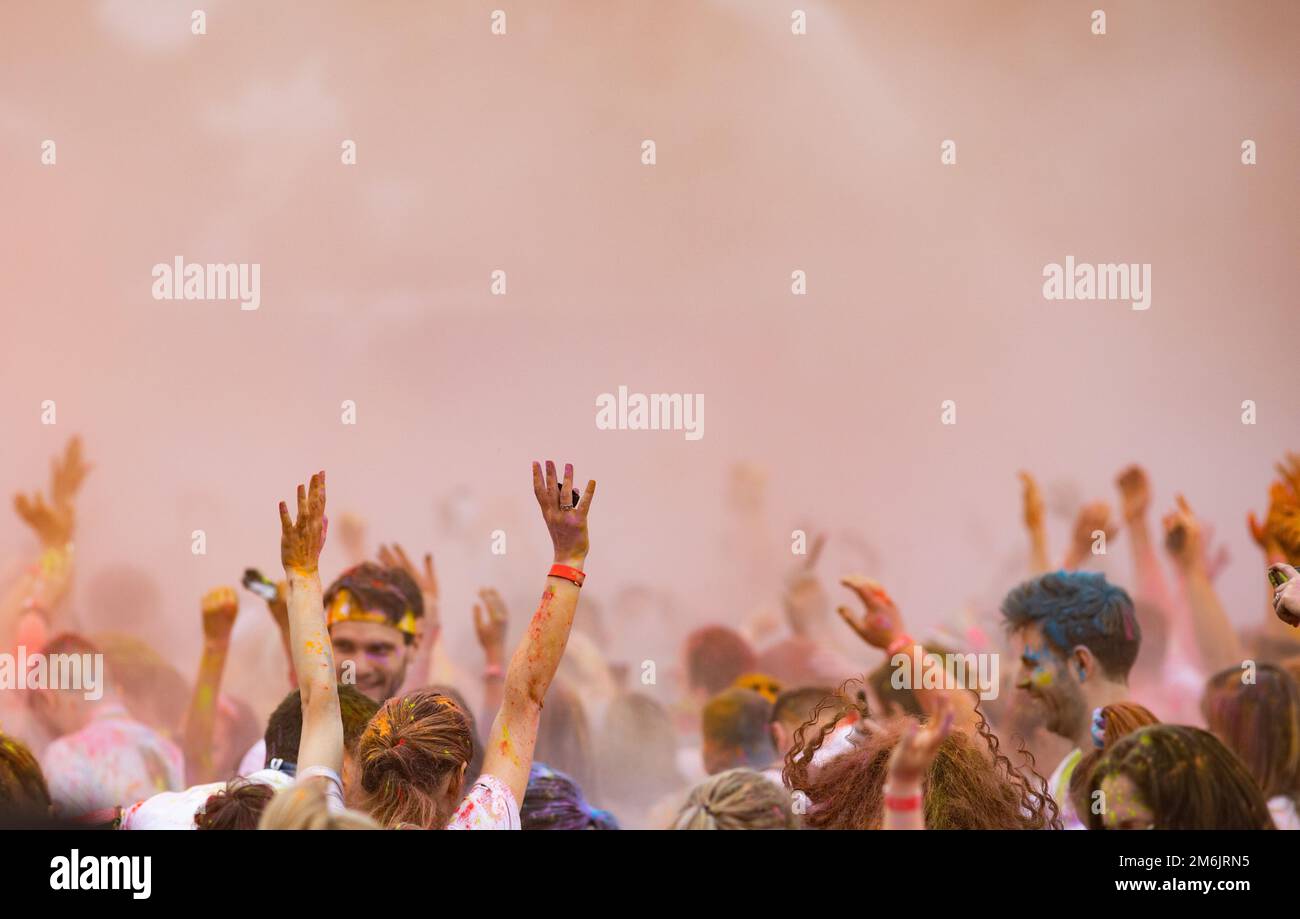 Color festival in city crowd celebrating Stock Photo - Alamy