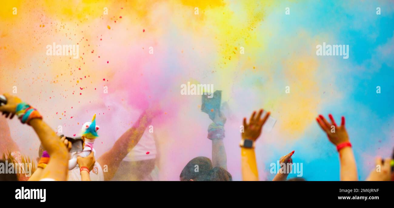Color festival in city crowd celebrating Stock Photo - Alamy