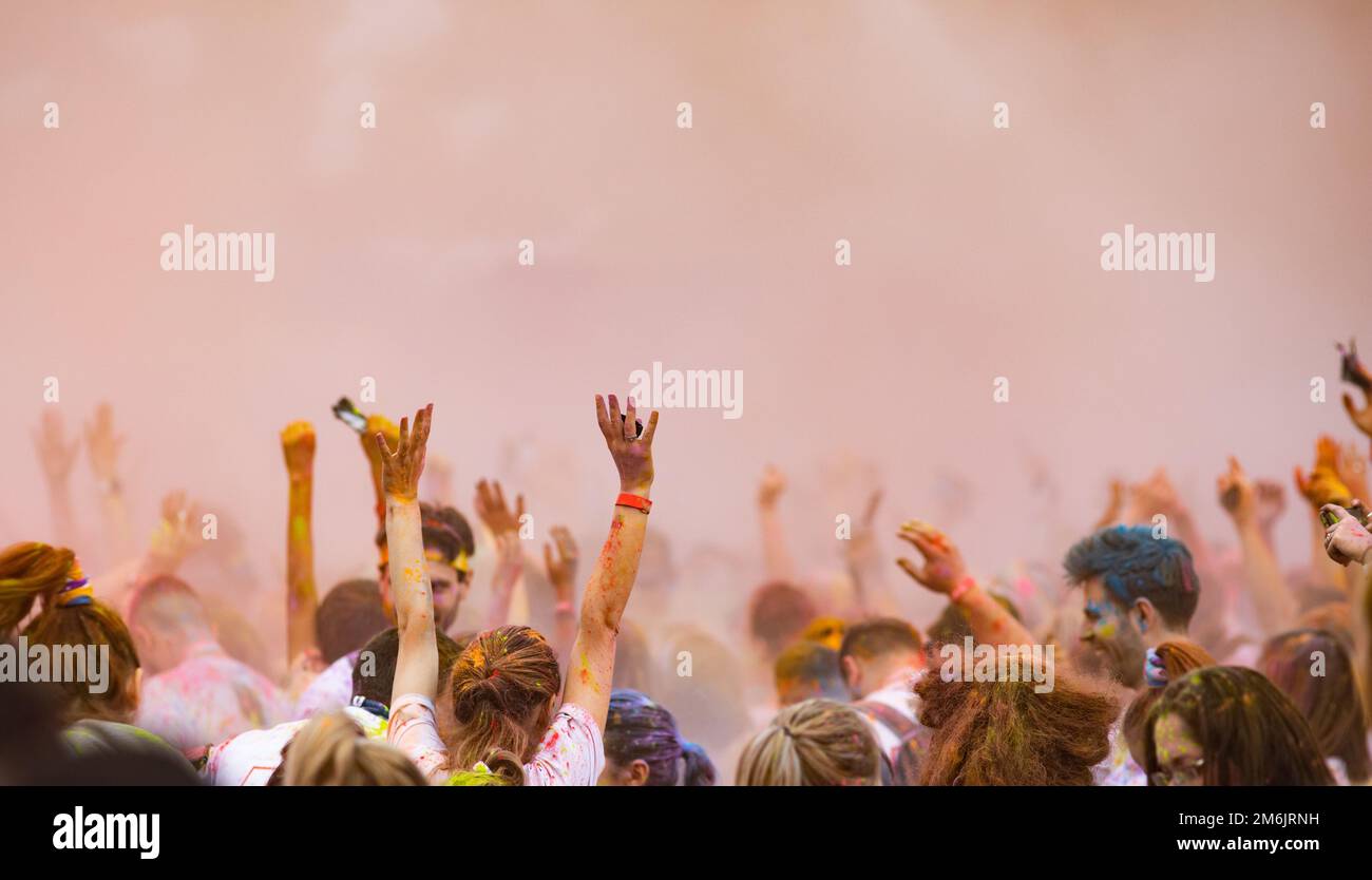 Color festival in city crowd celebrating Stock Photo - Alamy