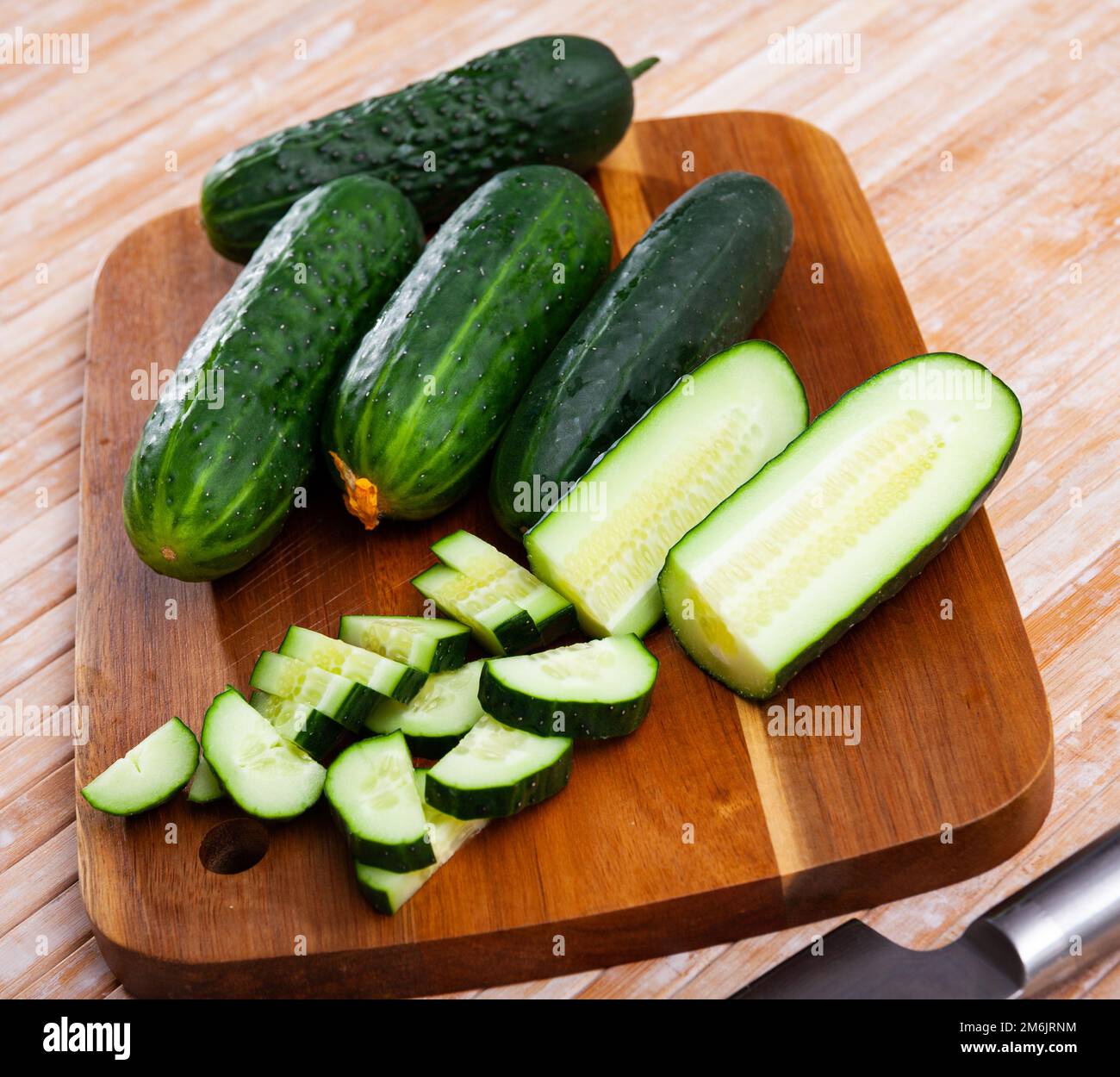 Sliced cucumbers on wooden table, food ingredients Stock Photo - Alamy