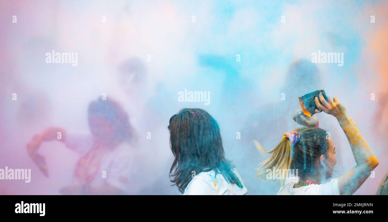 Color festival in city crowd celebrating Stock Photo - Alamy
