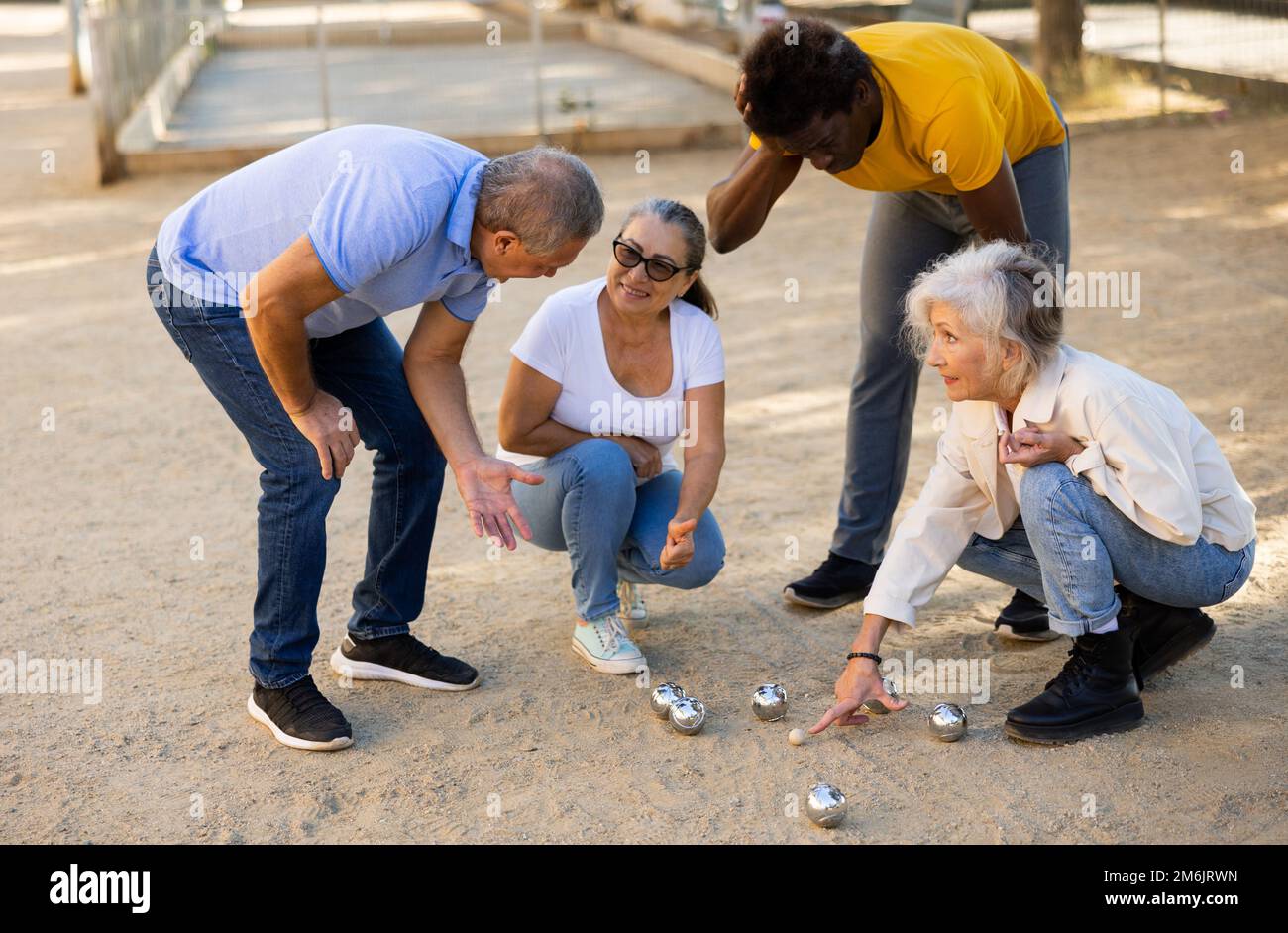 Multiracial mature adult people measuring distance between balls in ...
