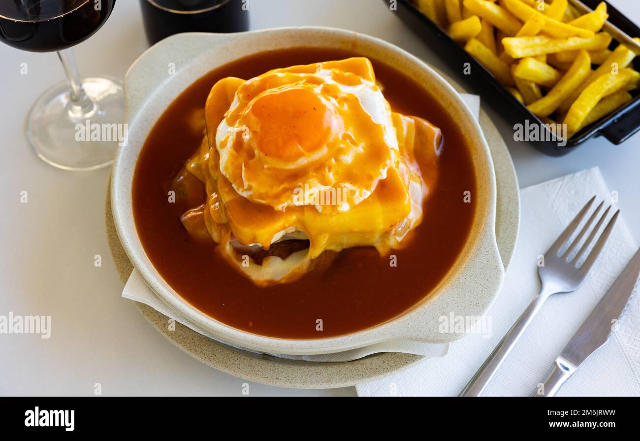 Traditional Portuguese sandwich, francesinha, served on table Stock ...