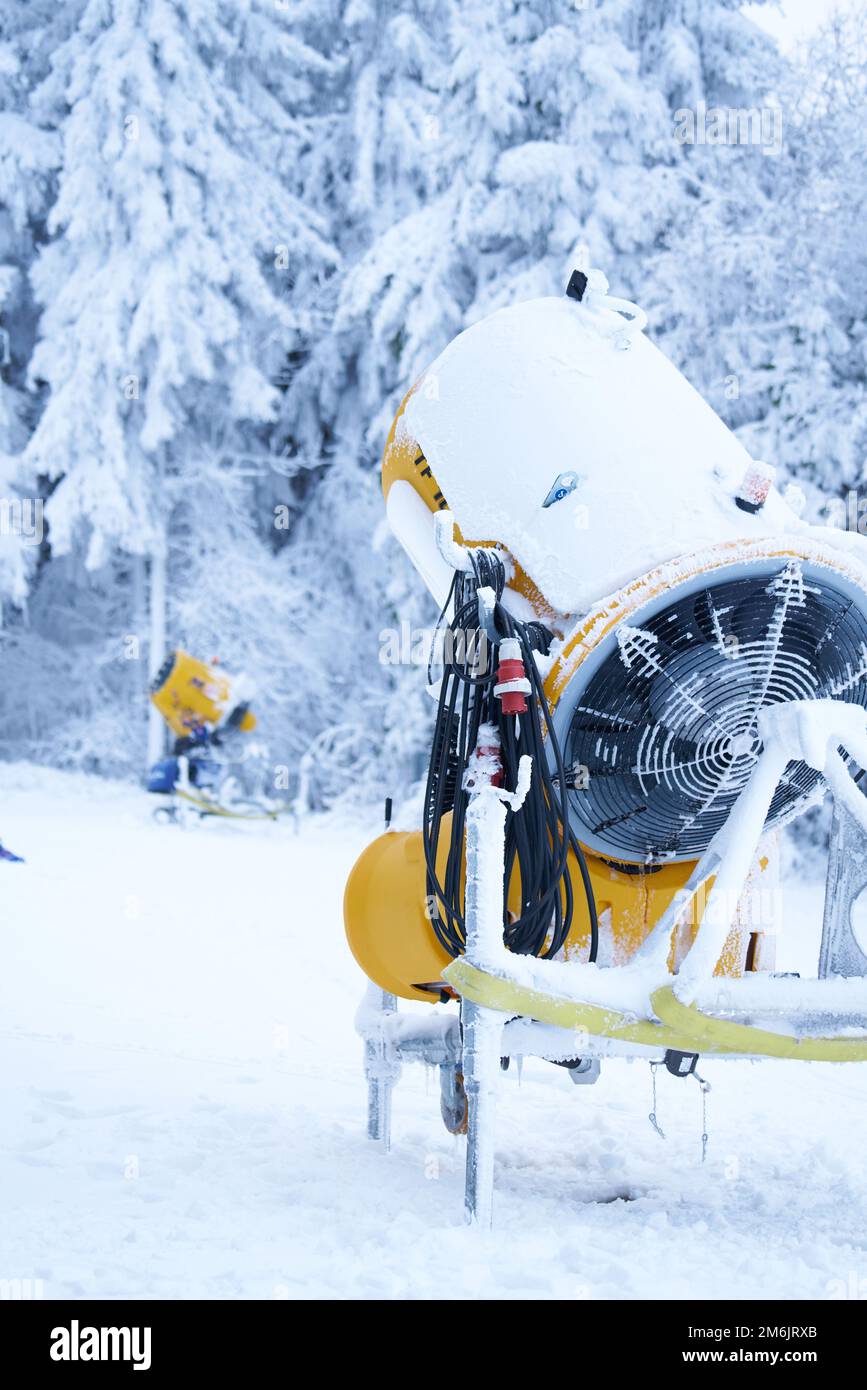 Yellow artificial snow cannon under snow on Wasserkuppe in Rhoen Hesse ...