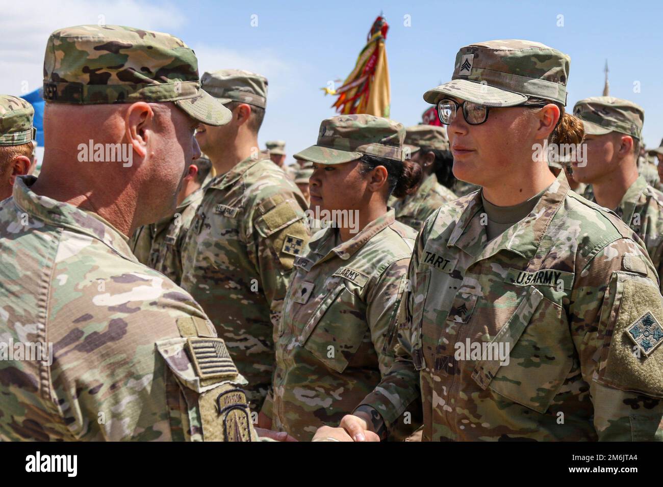 A soldier receives an award from Col. Andrew Kiser, commander of 2nd ...