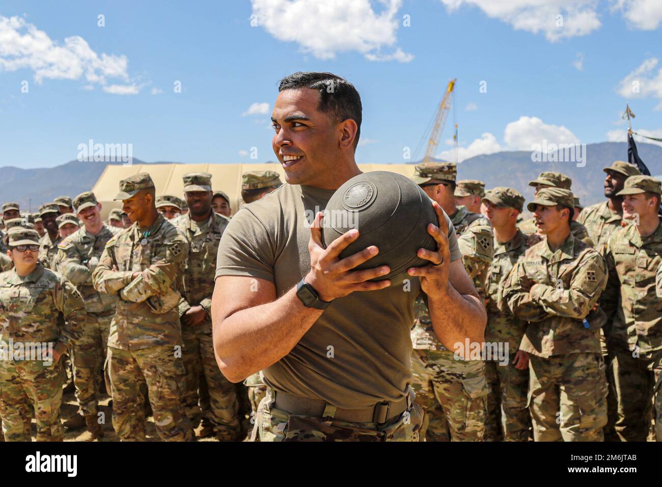 A soldier competes in a standing power throw competition during a 2nd ...