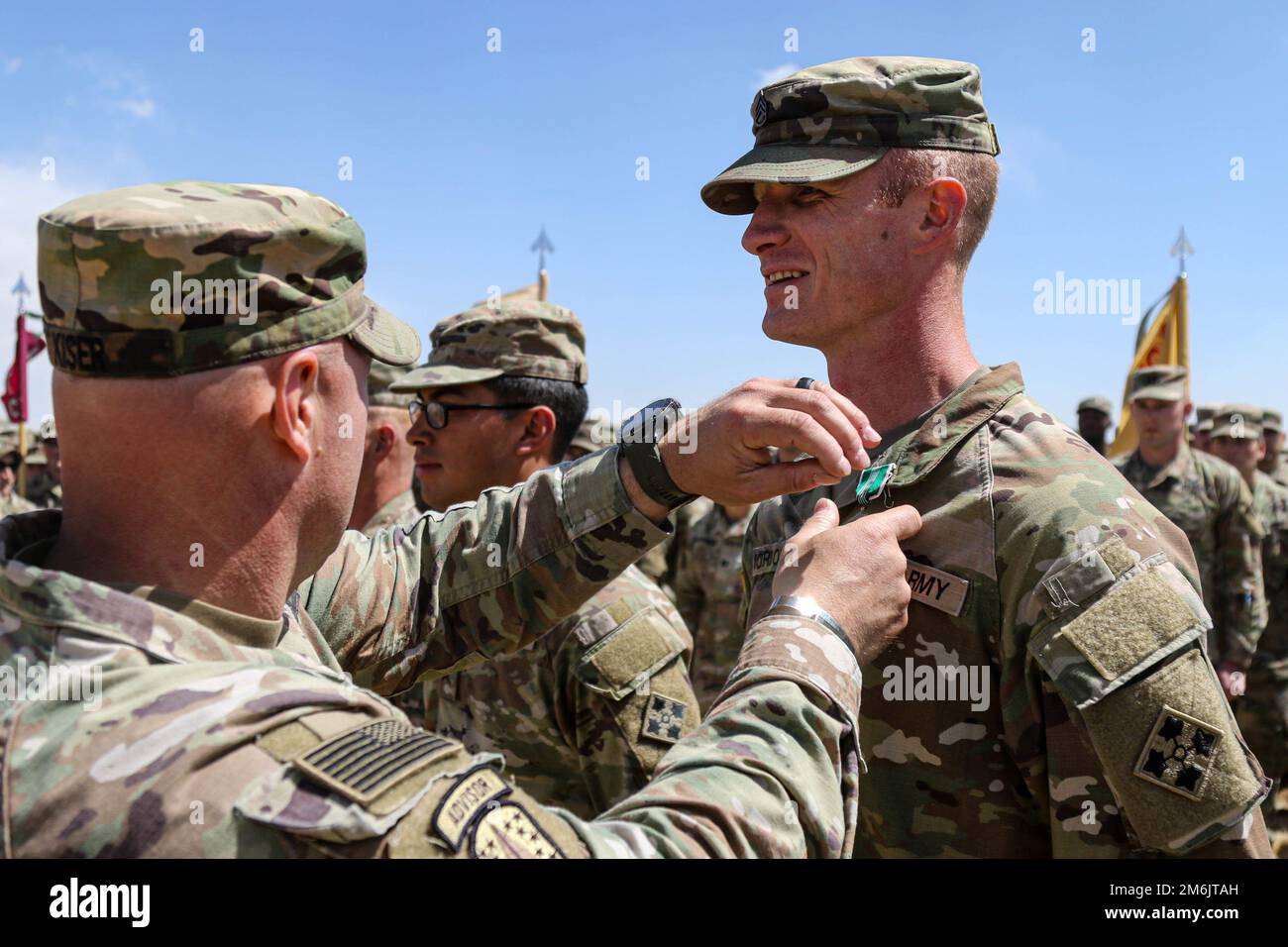 A soldier receives an award from Col. Andrew Kiser, commander of 2nd ...