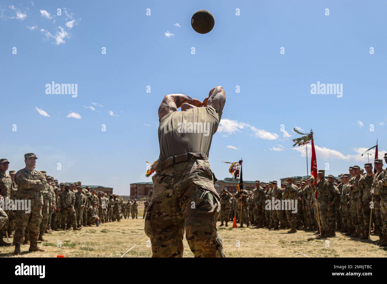 A soldier competes in a standing power throw competition during a 2nd ...