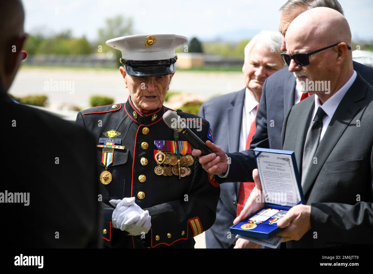 Former Marine Sgt. John Cole presents the family of Cpl. David Milano ...