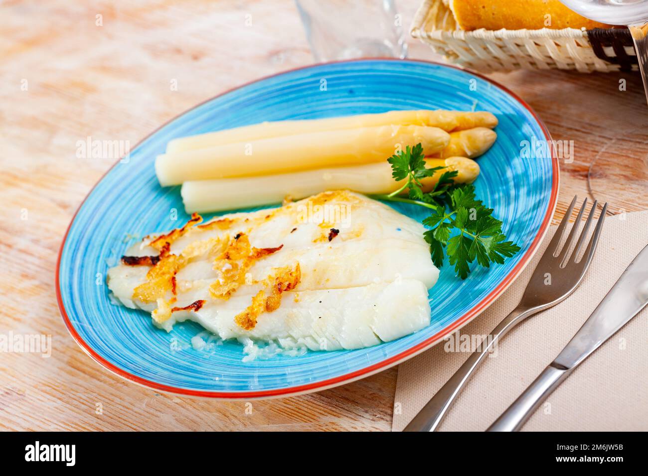 Baked Atlantic halibut fillet with asparagus Stock Photo - Alamy