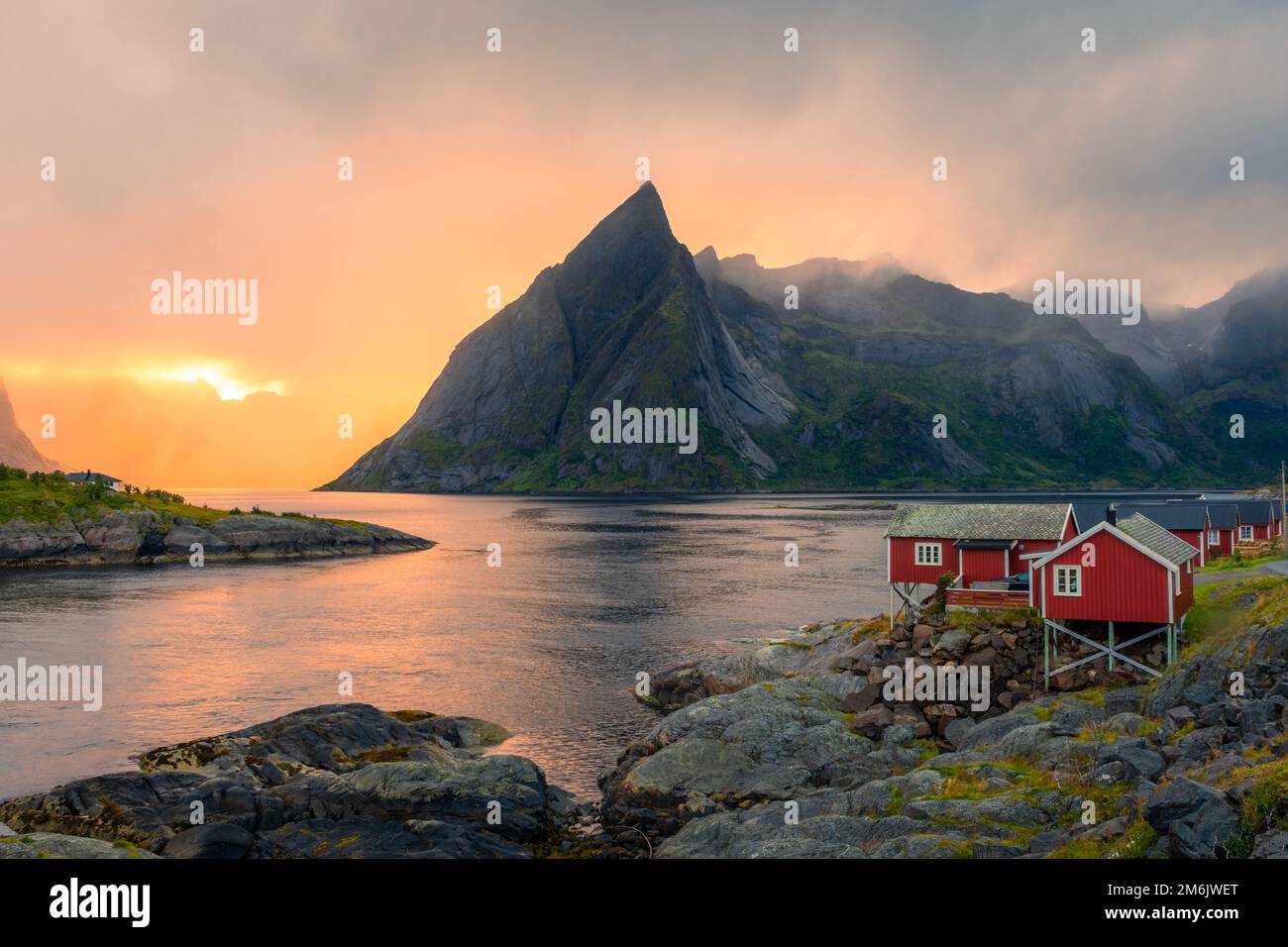 Amazing sunset through the mist and the Reinebringen Mount over the red ...