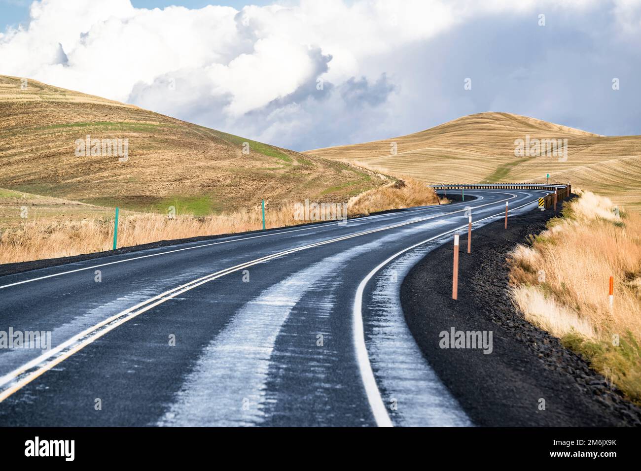 Scenic autumn landscape with a winding narrow highway road lost between ...