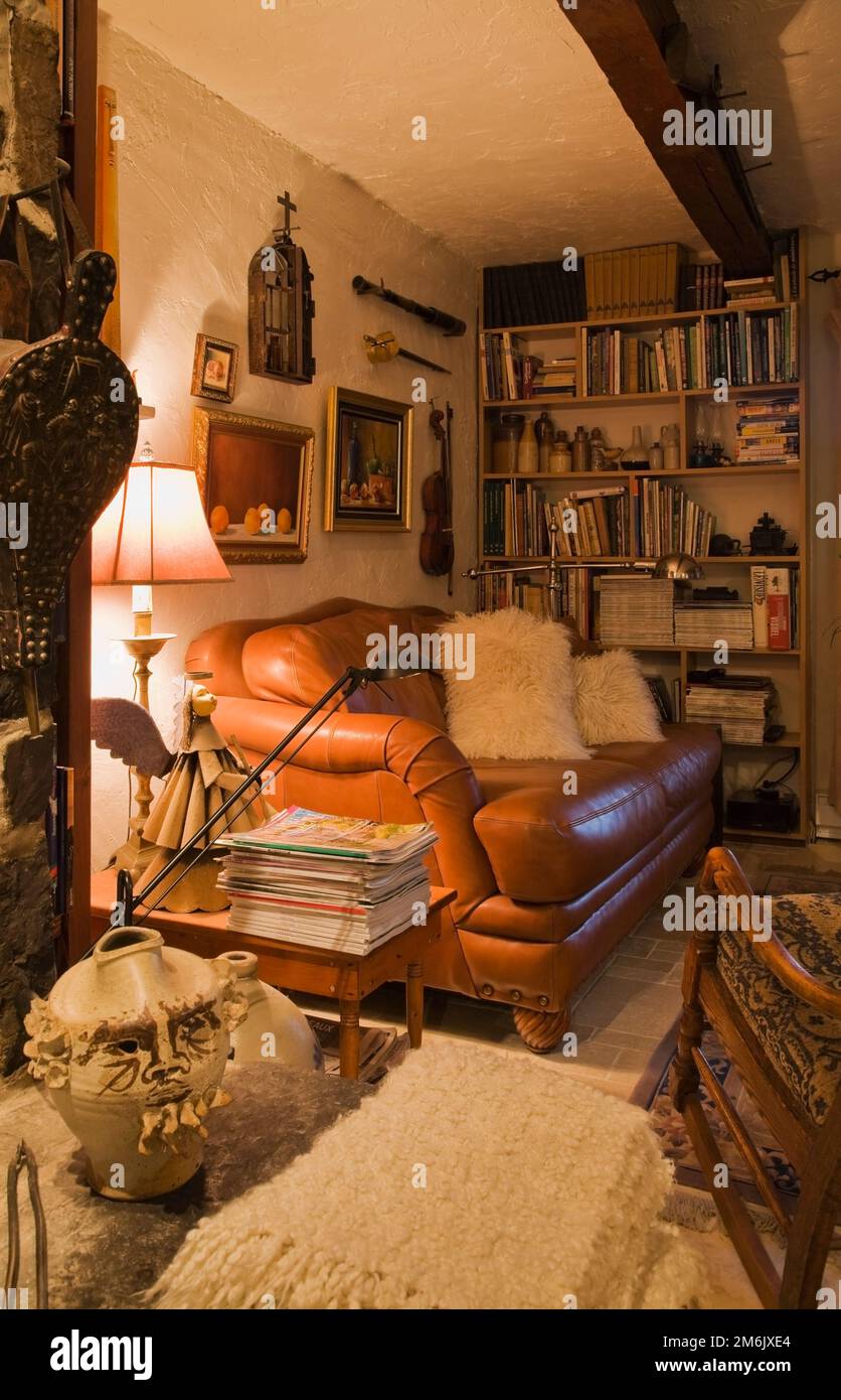 Brown leather sofa in reading room inside old 1809 cottage style home ...