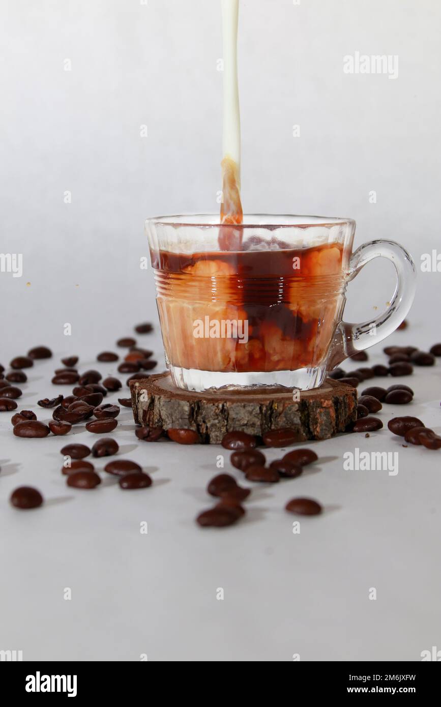 Creamer poured into coffee Stock Photo - Alamy