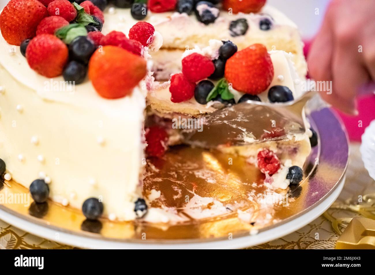 Woman cutting cake Stock Photo - Alamy