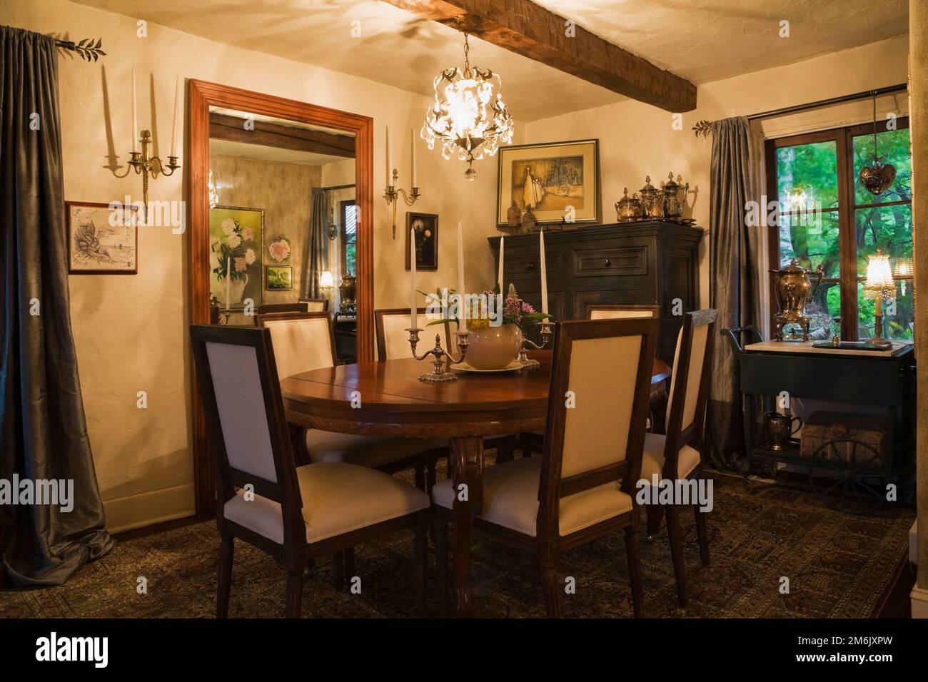 Antique wooden oval table and upholstered high back chairs in dining ...