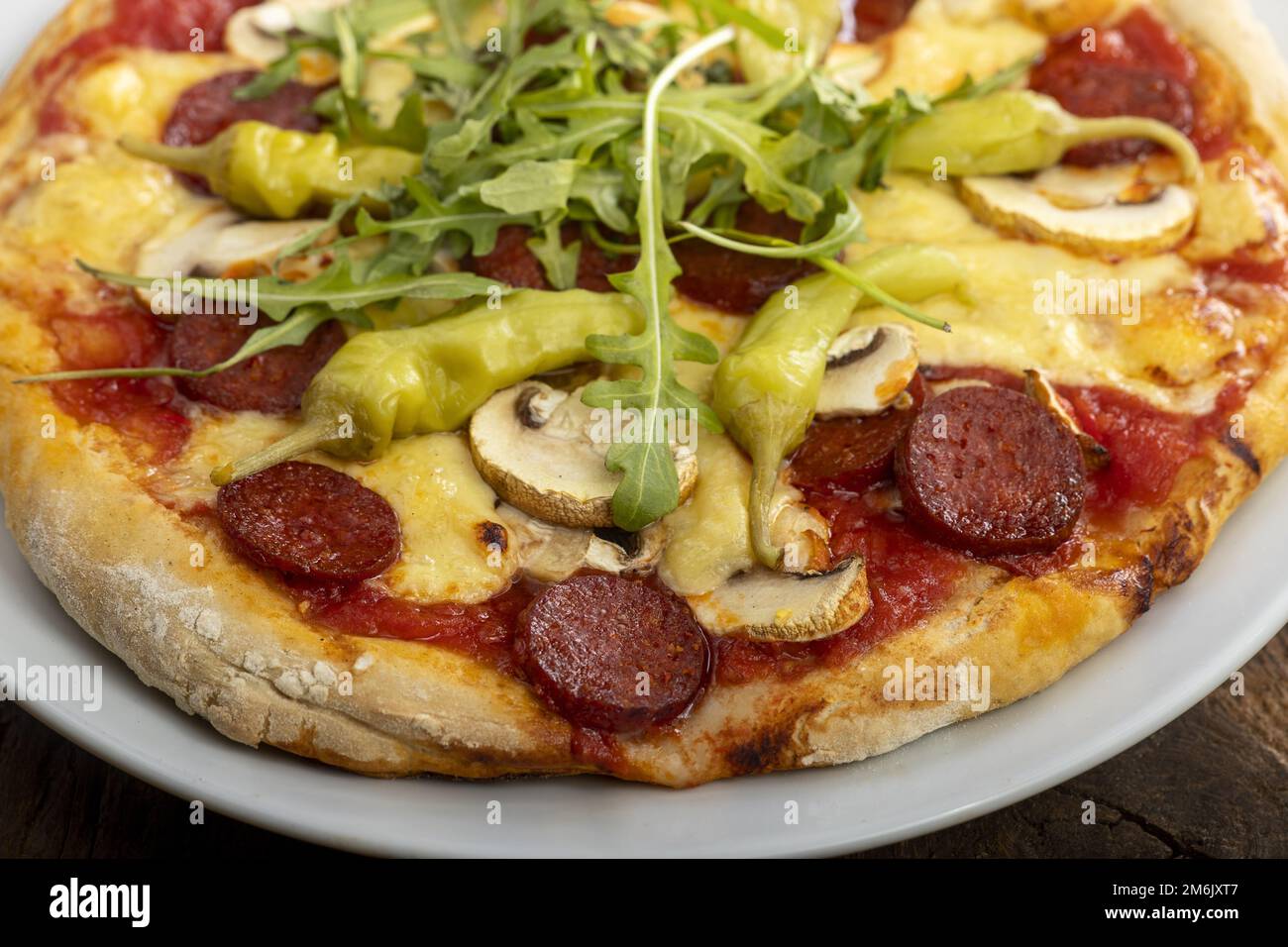 Pizza with salami on wood Stock Photo - Alamy