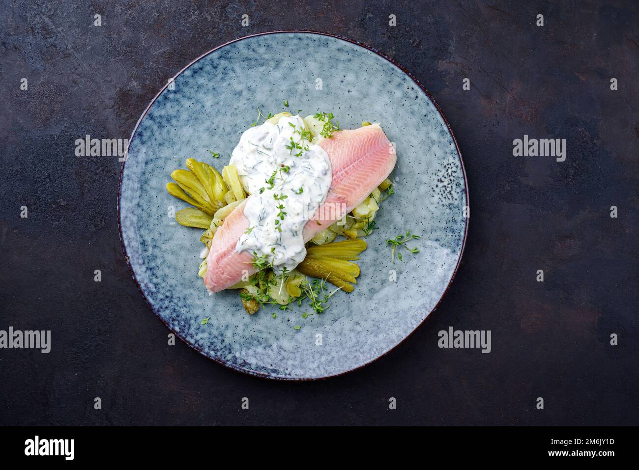 Modern style traditional smoked rainbow trout with boiled potato salad ...