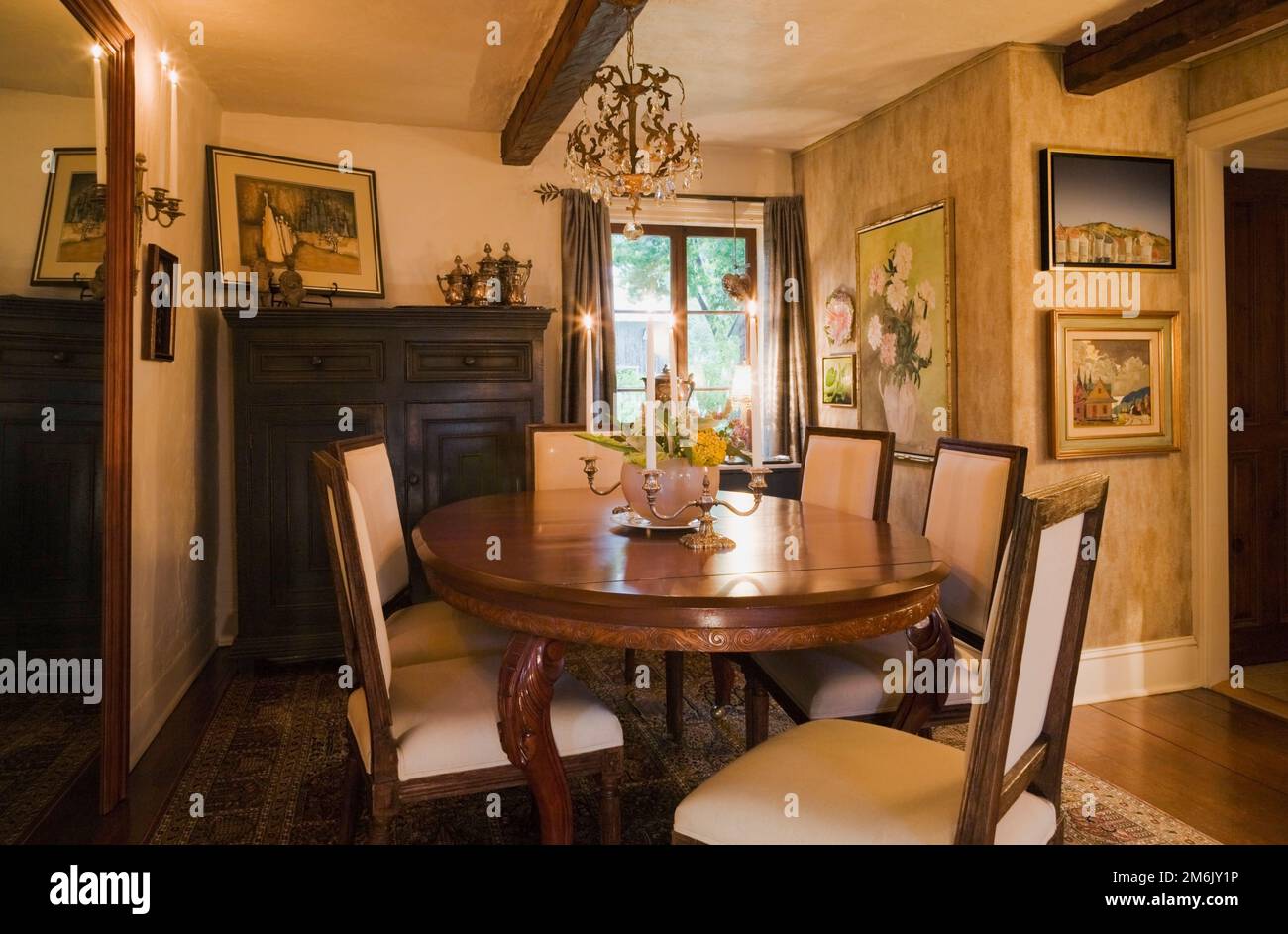 Antique wooden oval table and upholstered high back chairs in dining ...