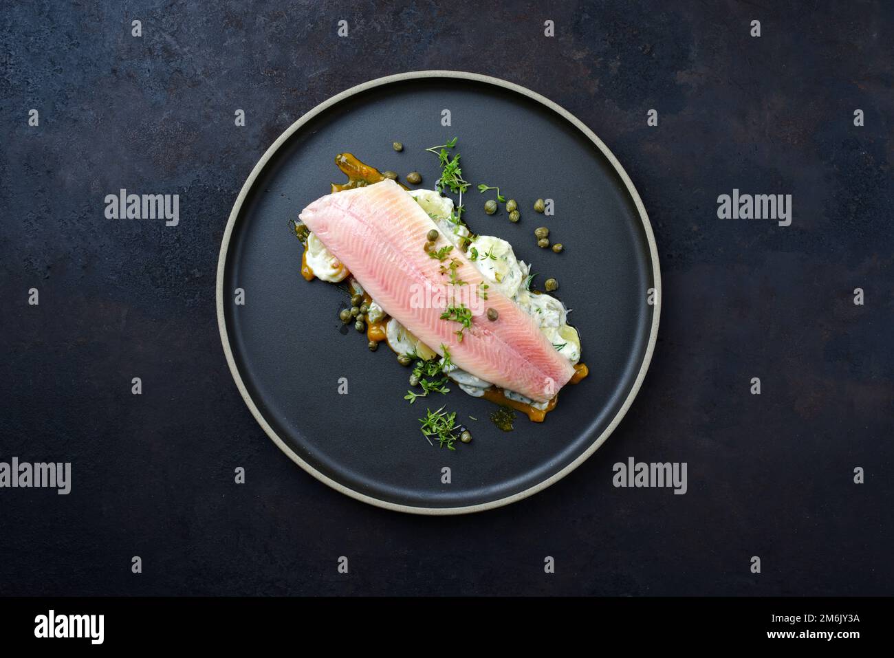 Modern style traditional smoked rainbow trout with boiled potato salad ...