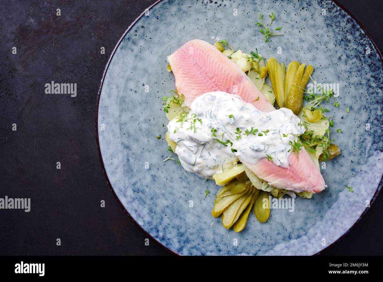 Modern style traditional smoked rainbow trout with boiled potato salad ...
