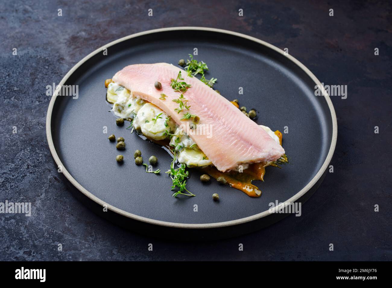 Modern style traditional smoked rainbow trout with boiled potato salad ...