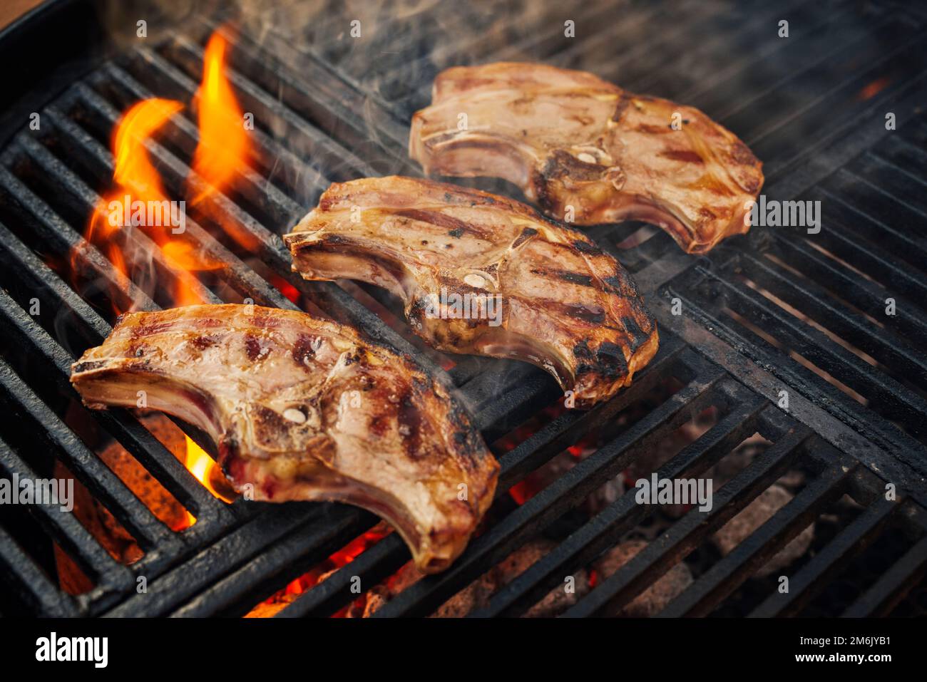 Barbecue lamb saddle back chop steak grilled as close-up on a charcoal ...