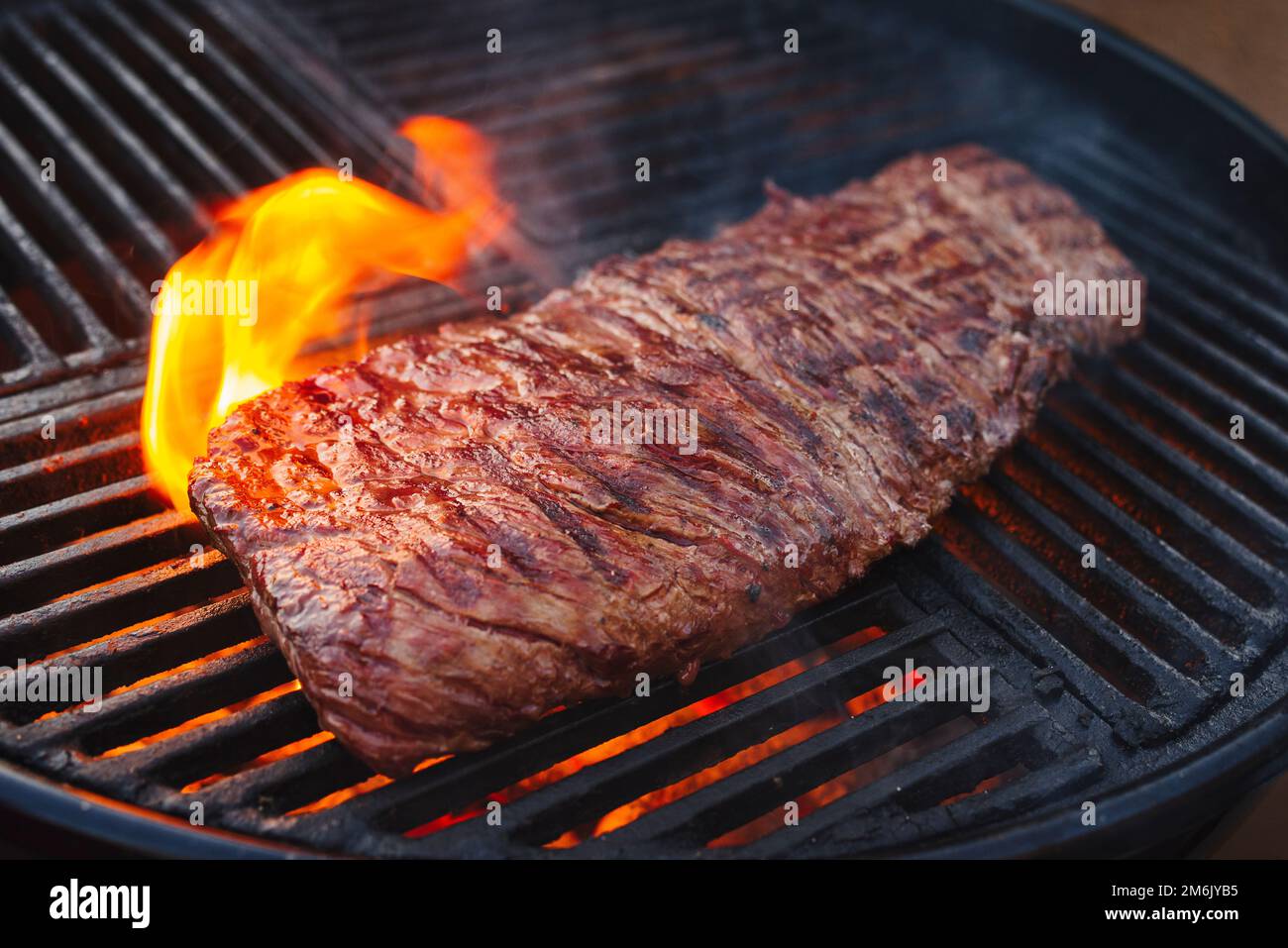 Traditional American barbecue bavette steak as close-up on a charcoal ...