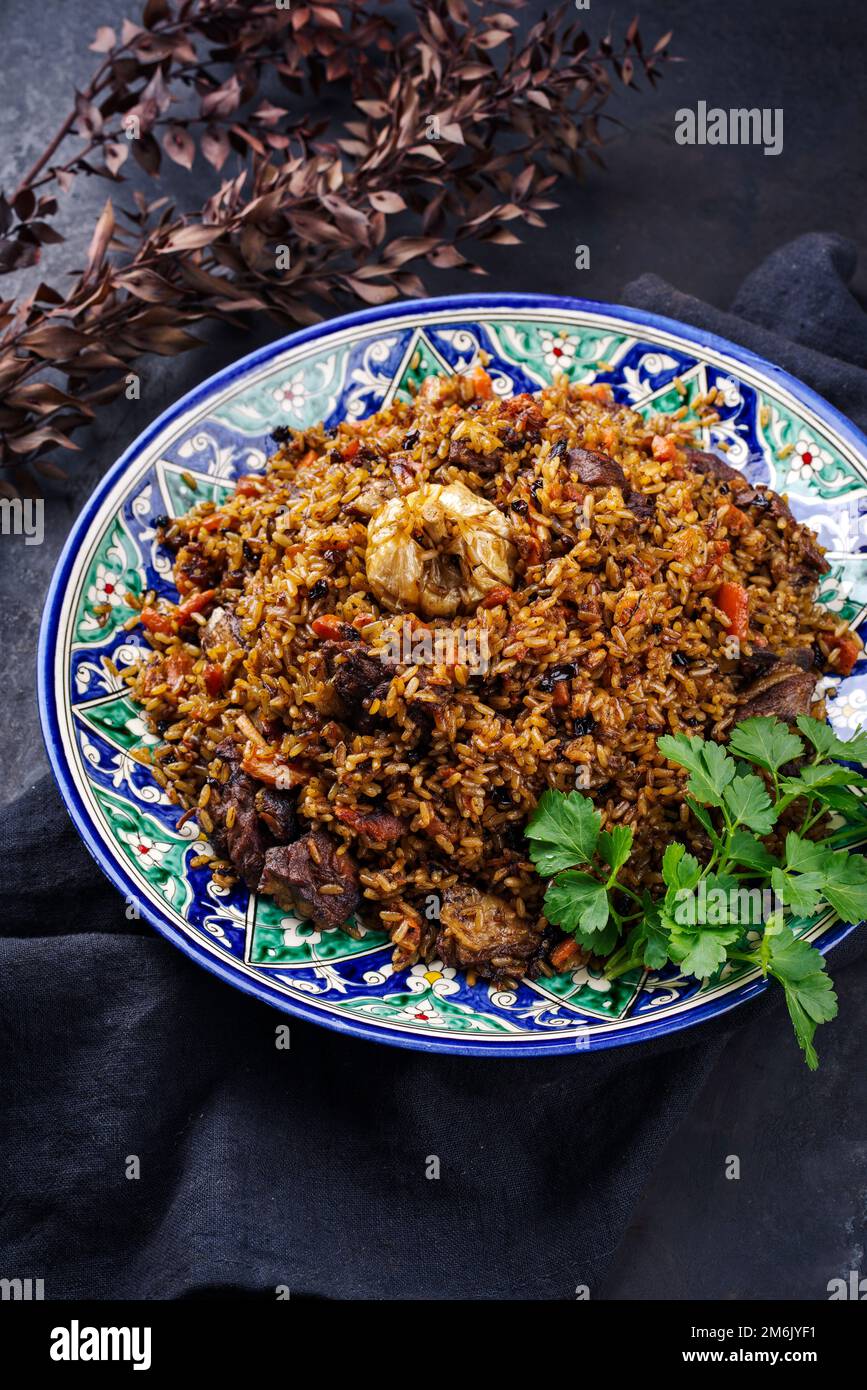 Traditional Uzbek fergana plov with devsira rice and lamb meat served ...