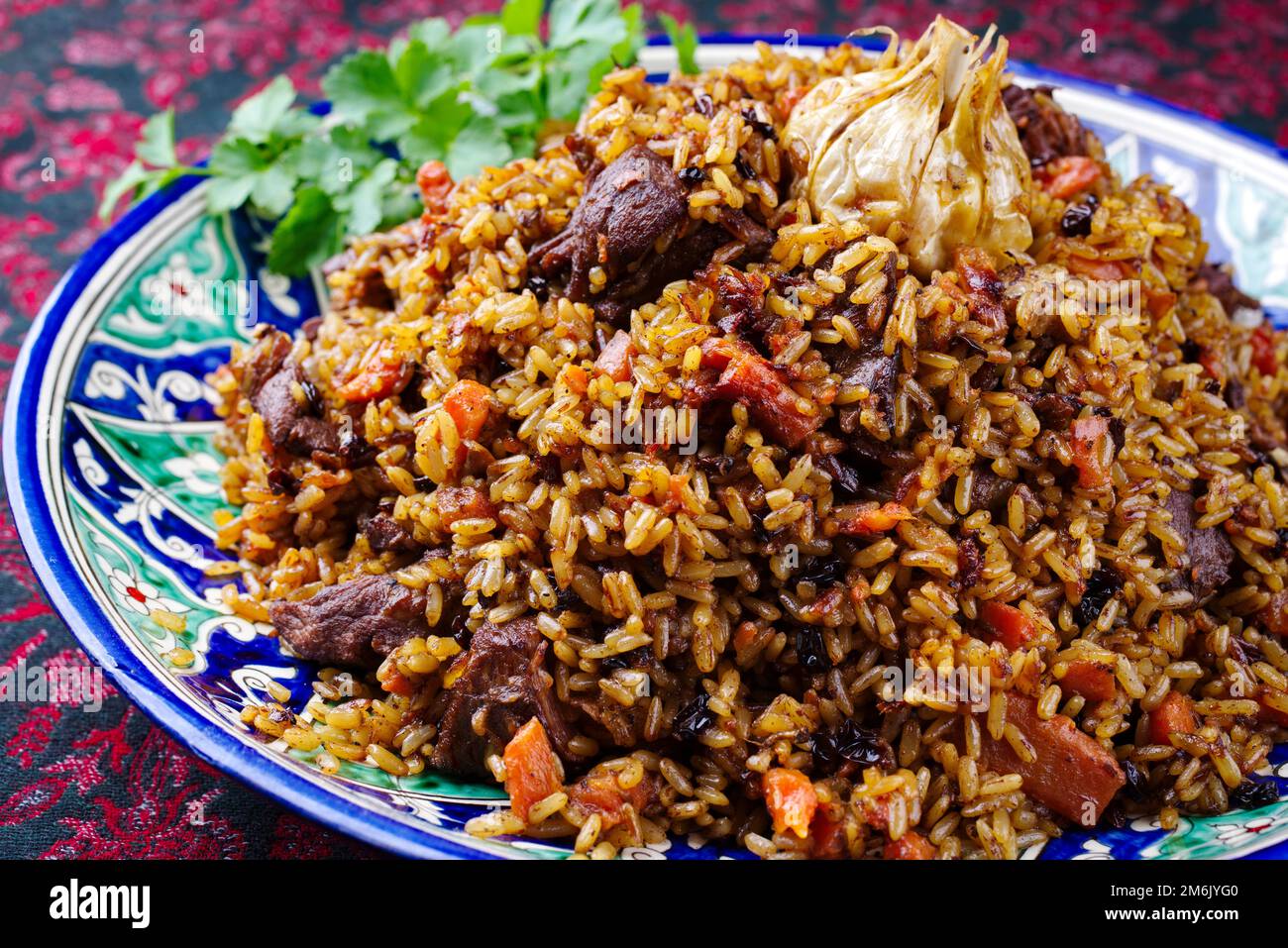 Traditional Uzbek fergana plov with devsira rice and lamb meat served ...