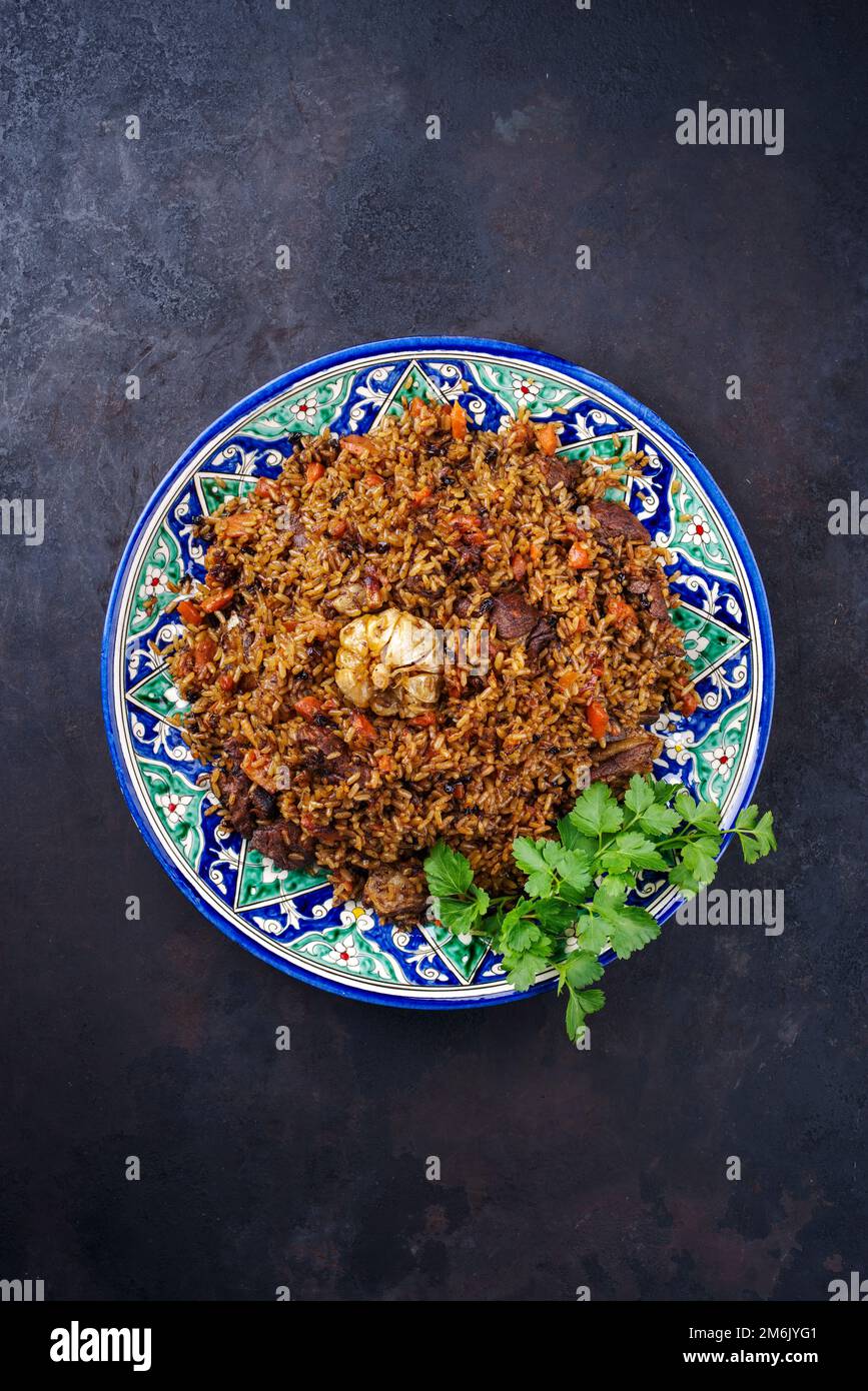 Traditional Uzbek fergana plov with devsira rice and lamb meat served ...
